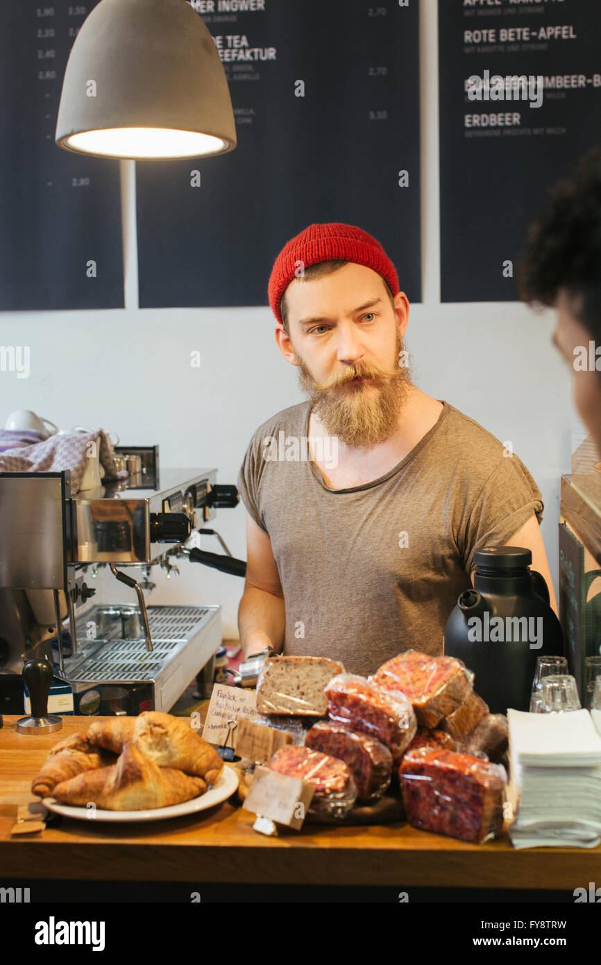 Barista behind cafe counter Stock Photo - Alamy