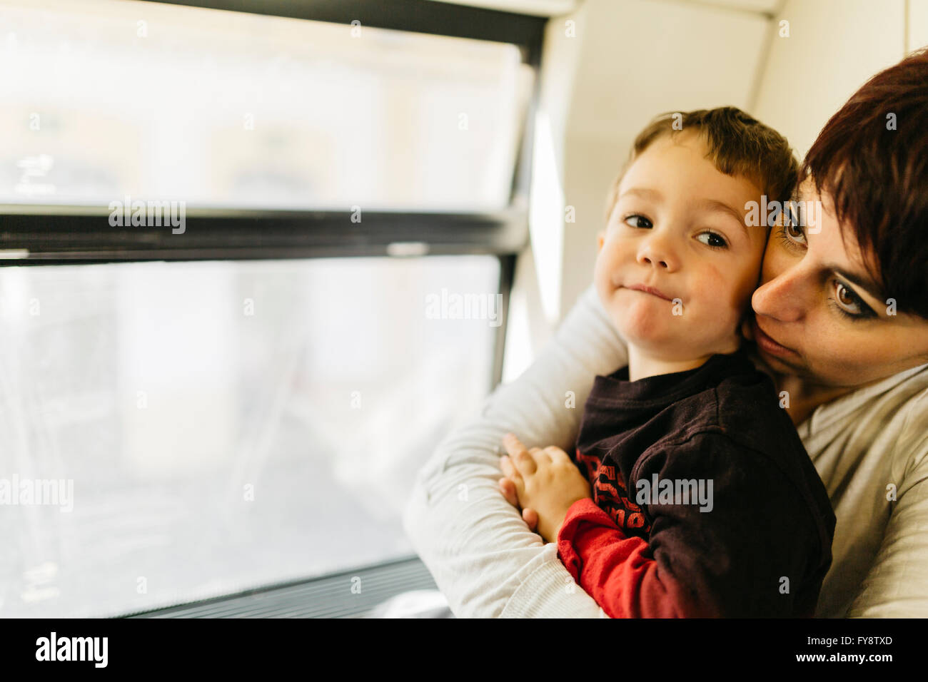 Little boy enjoying his first train ride with his mother Stock Photo ...