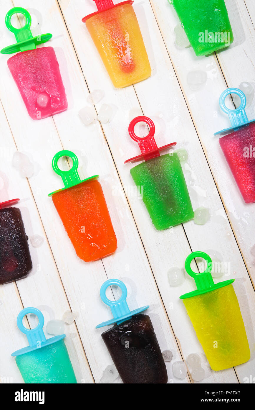 Different colorful ice lollies and ice cubes on white ground Stock ...