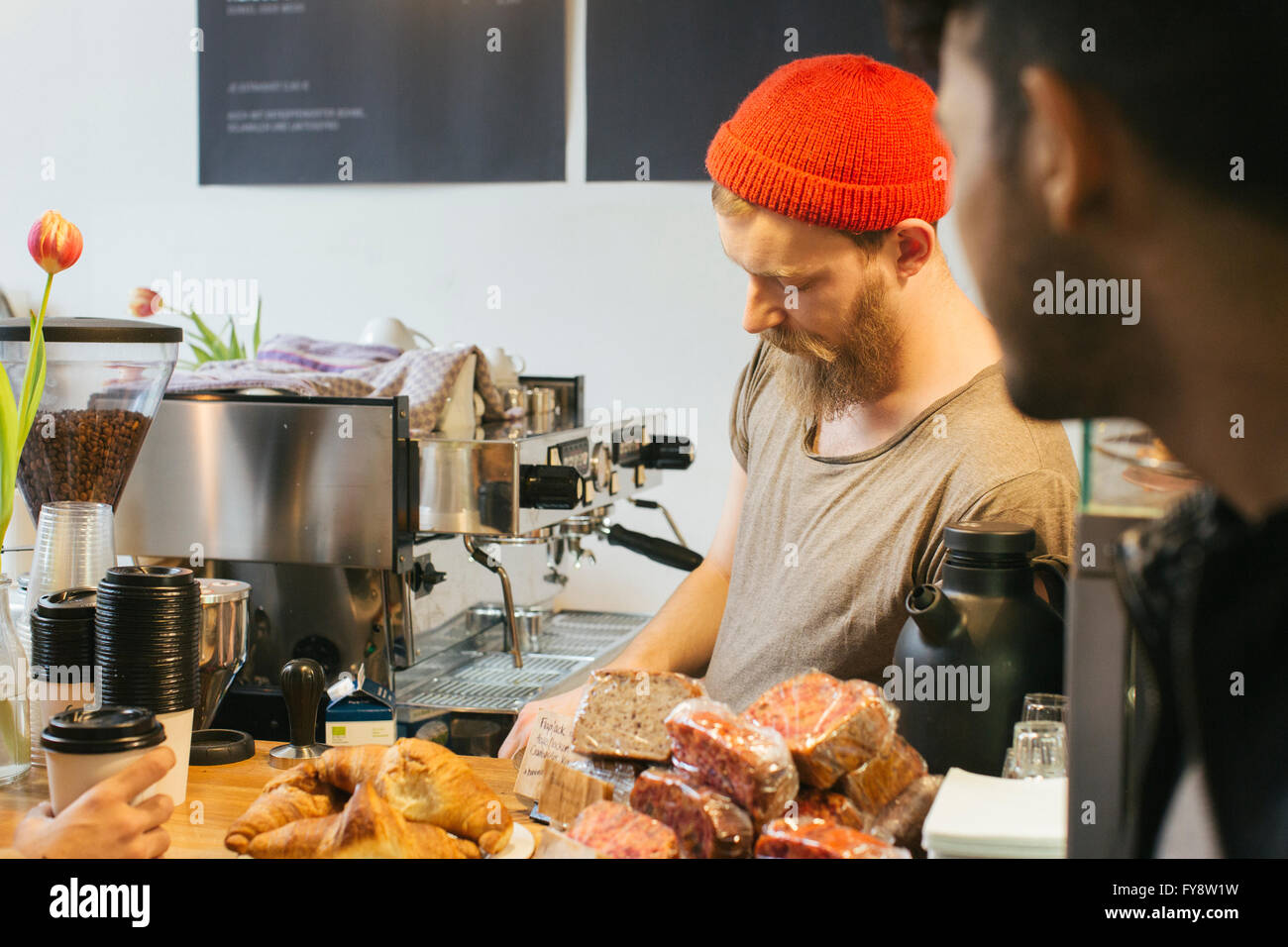 Barista behind cafe counter Stock Photo - Alamy