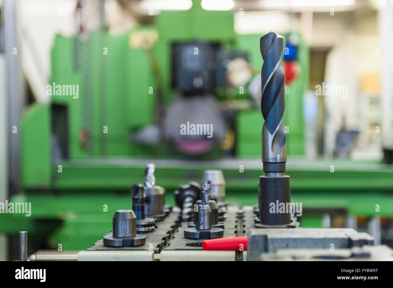 Assortment of drills and machine for tool-making in background Stock ...