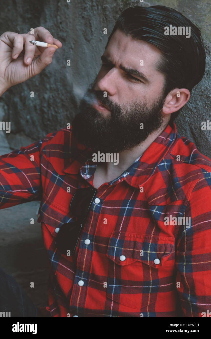 Portrait of smoking serious looking man with full beard Stock Photo - Alamy