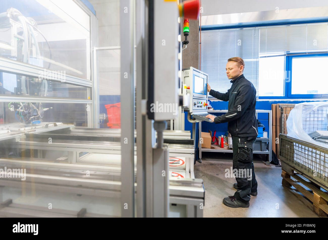 Man working at packaging machine in factory Stock Photo - Alamy