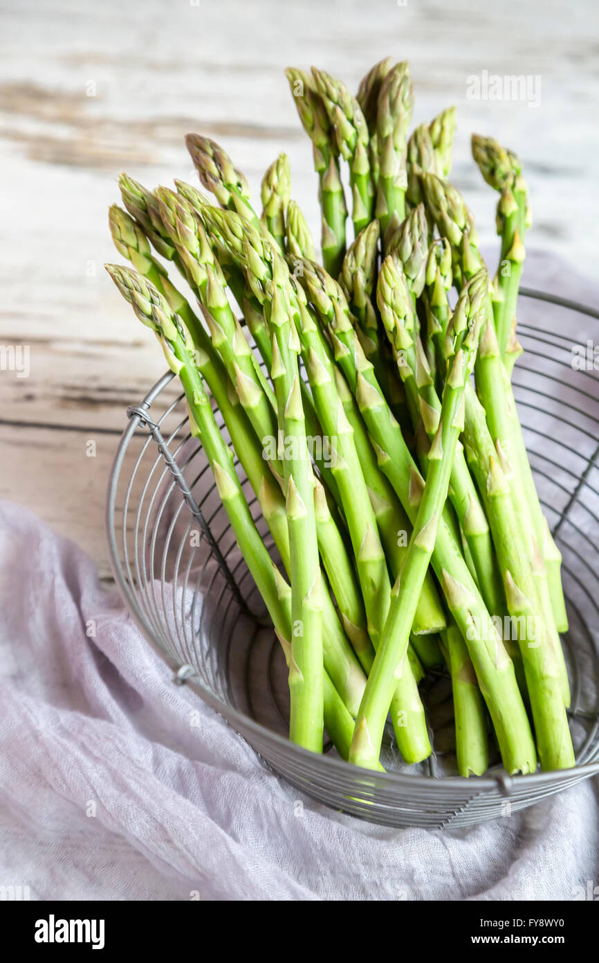 Mini organic green asparagus in a wire basket Stock Photo - Alamy