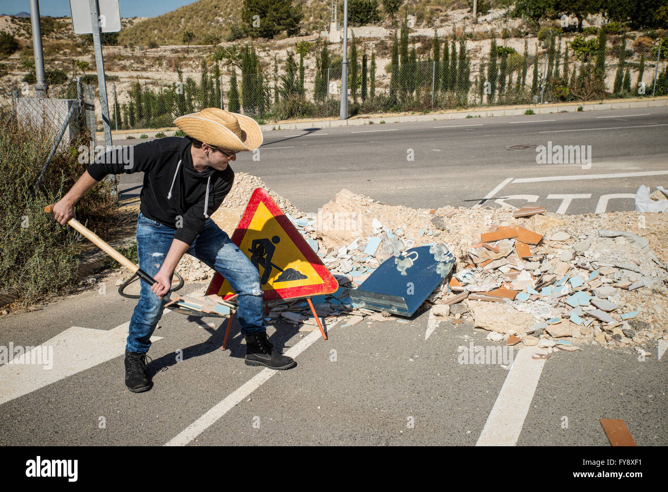 Young guy building a road block with construction rubble, a concept ...