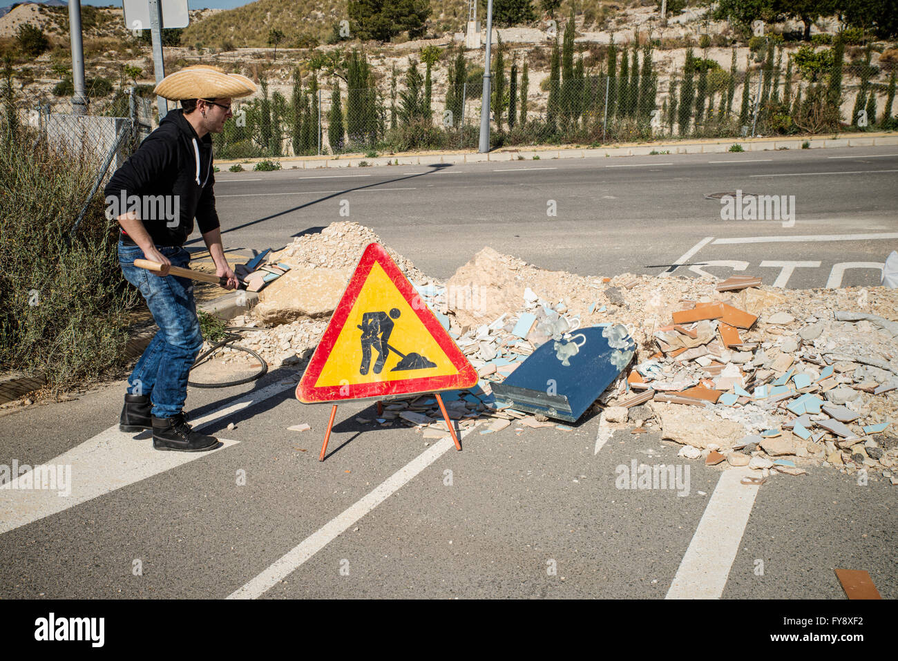 Young guy building a road block with construction rubble, a concept ...