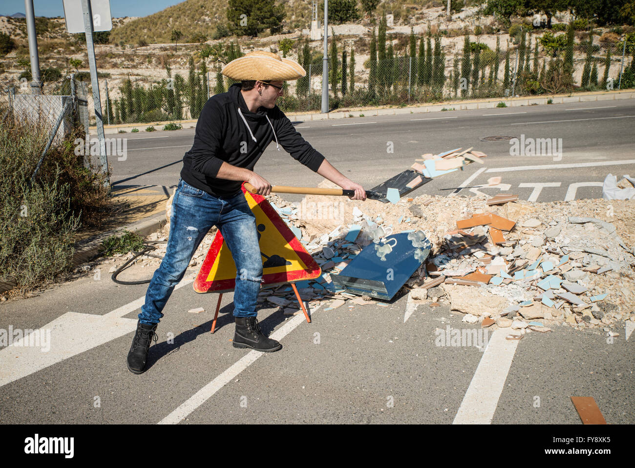 Young guy building a road block with construction rubble, a concept ...