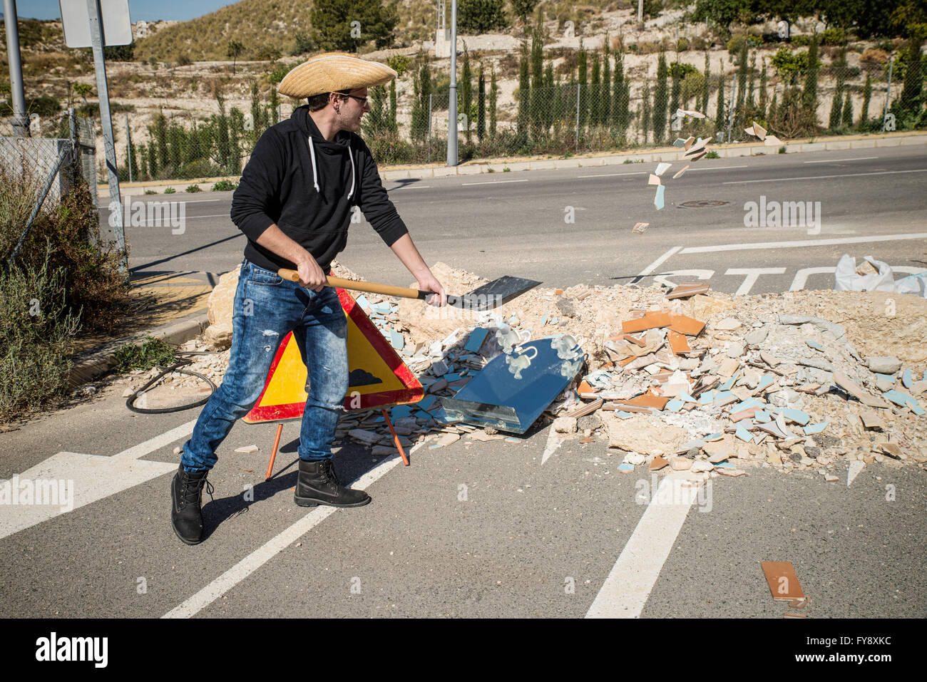 Young guy building a road block with construction rubble, a concept ...