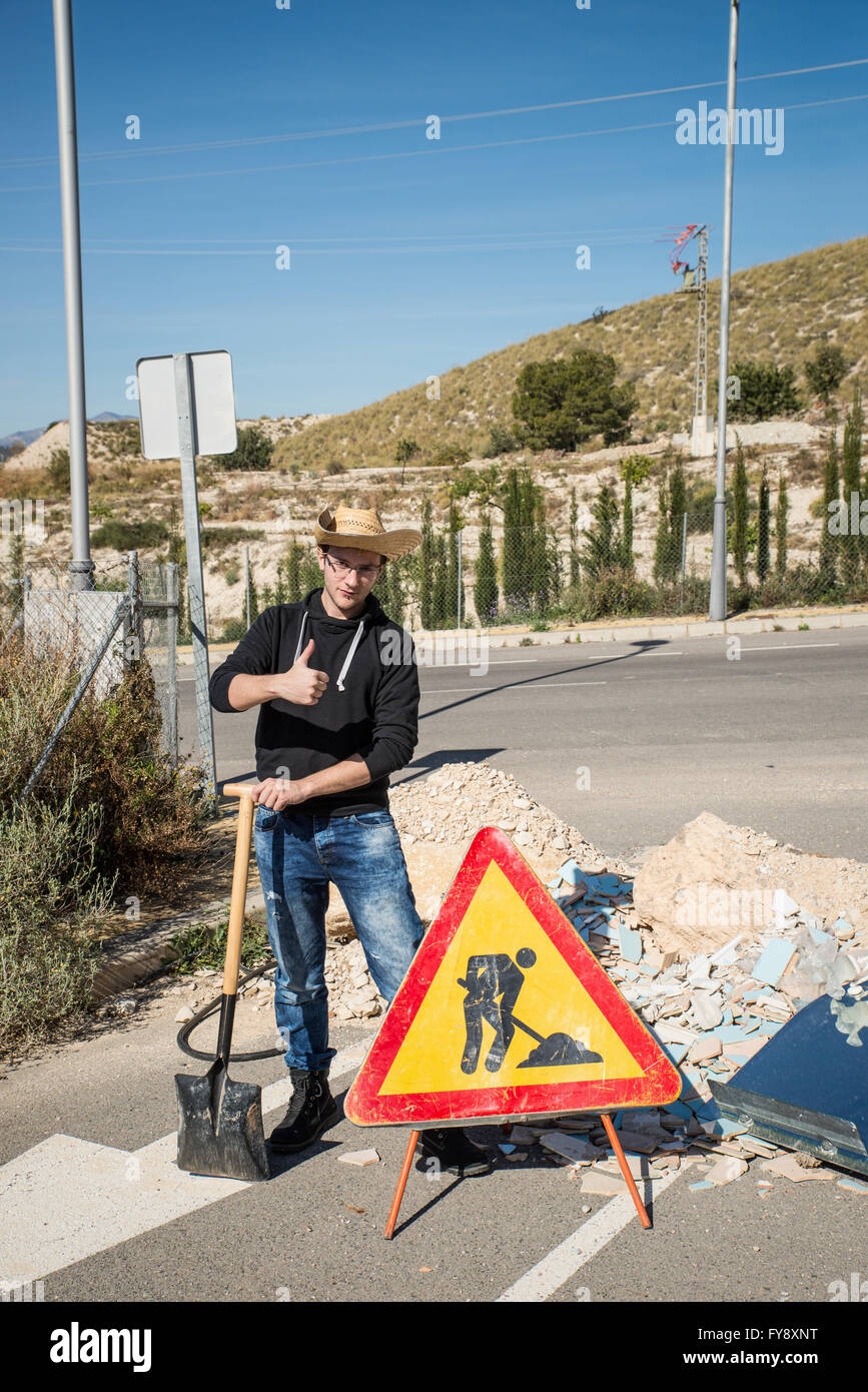 Young guy building a road block with construction rubble, a concept ...