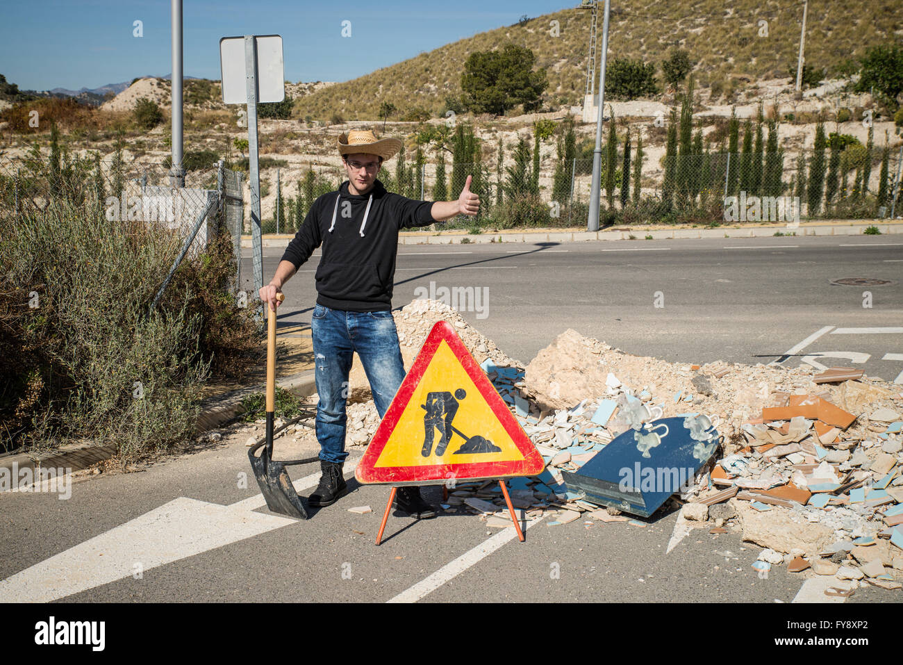Young guy building a road block with construction rubble, a concept ...