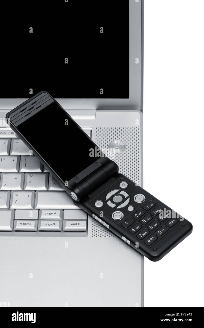 Mobile phone on the keyboard of a laptop Stock Photo - Alamy