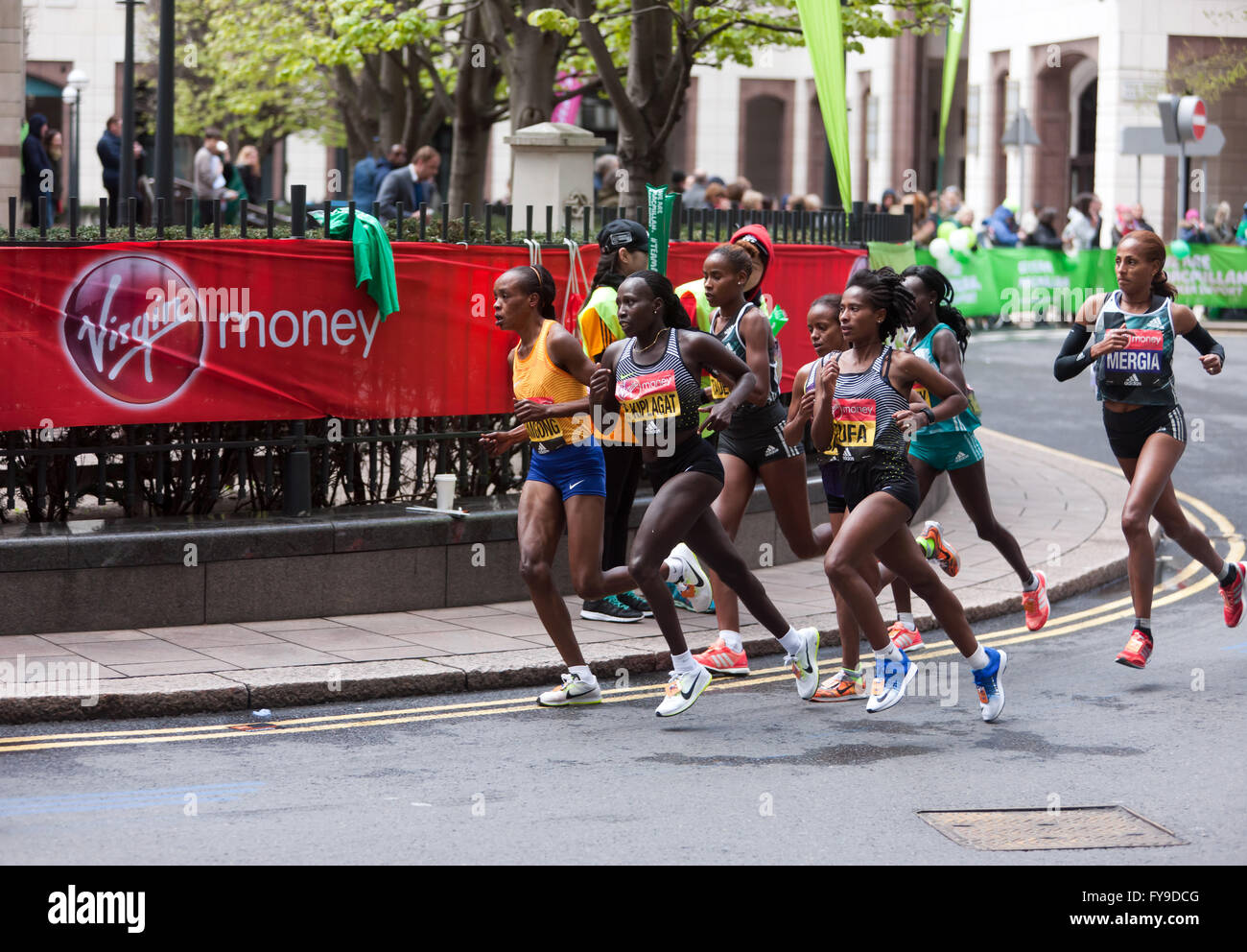 Jemima Sumgong, between the 18th and 19th mile marker, leading the ...