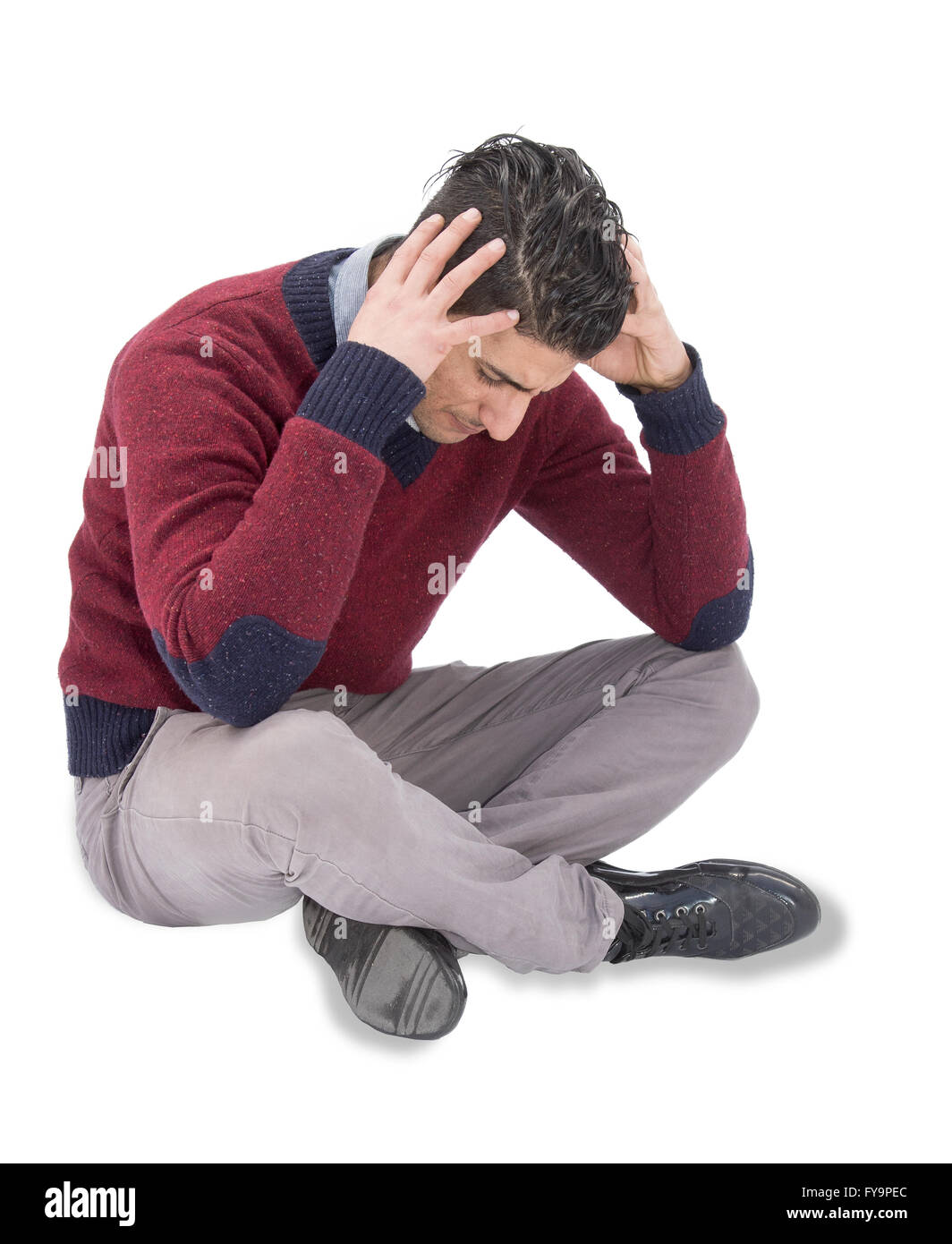 Depressed man sitting on the floor with his hands in his hair Stock ...
