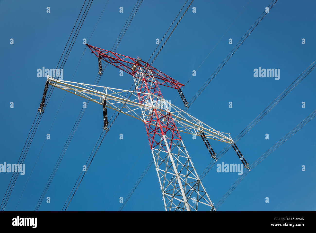 High voltage pylons on the clean blue sky Stock Photo - Alamy