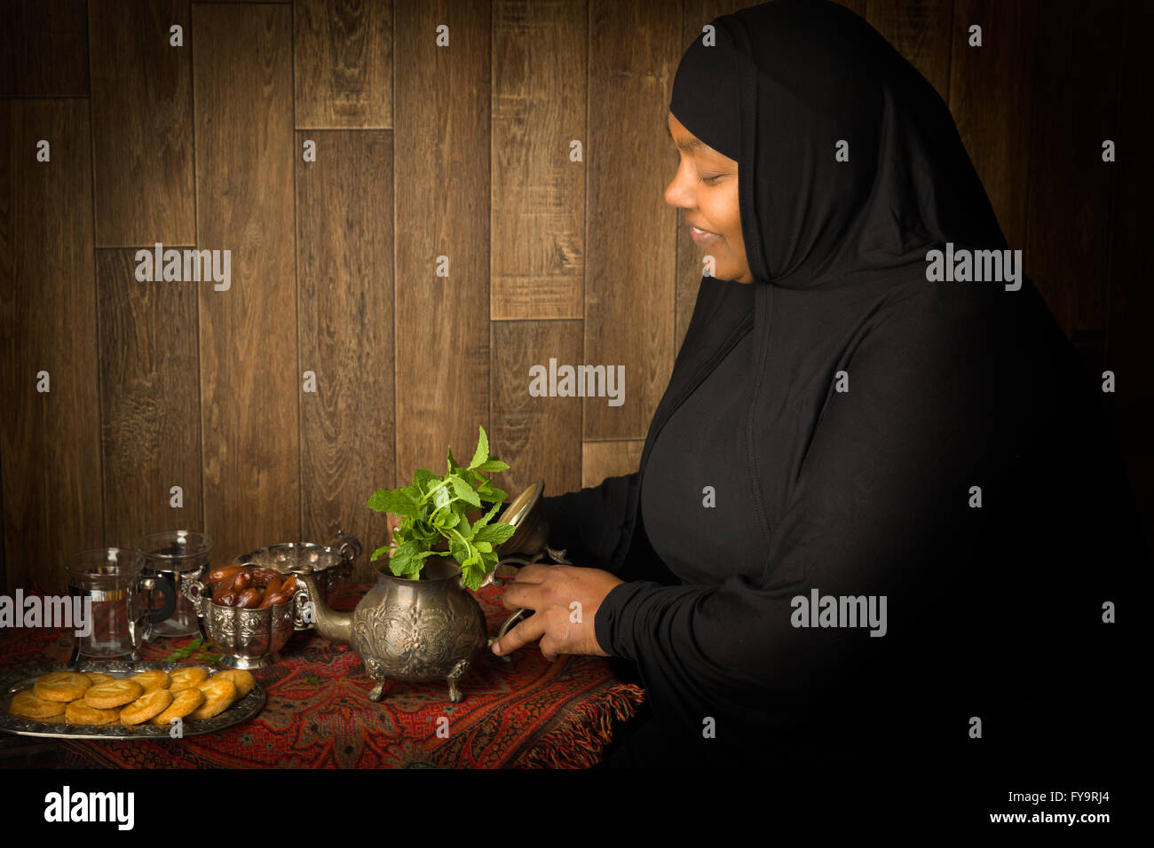 Hands of a muslim woman preparing mint tea the traditional way Stock ...