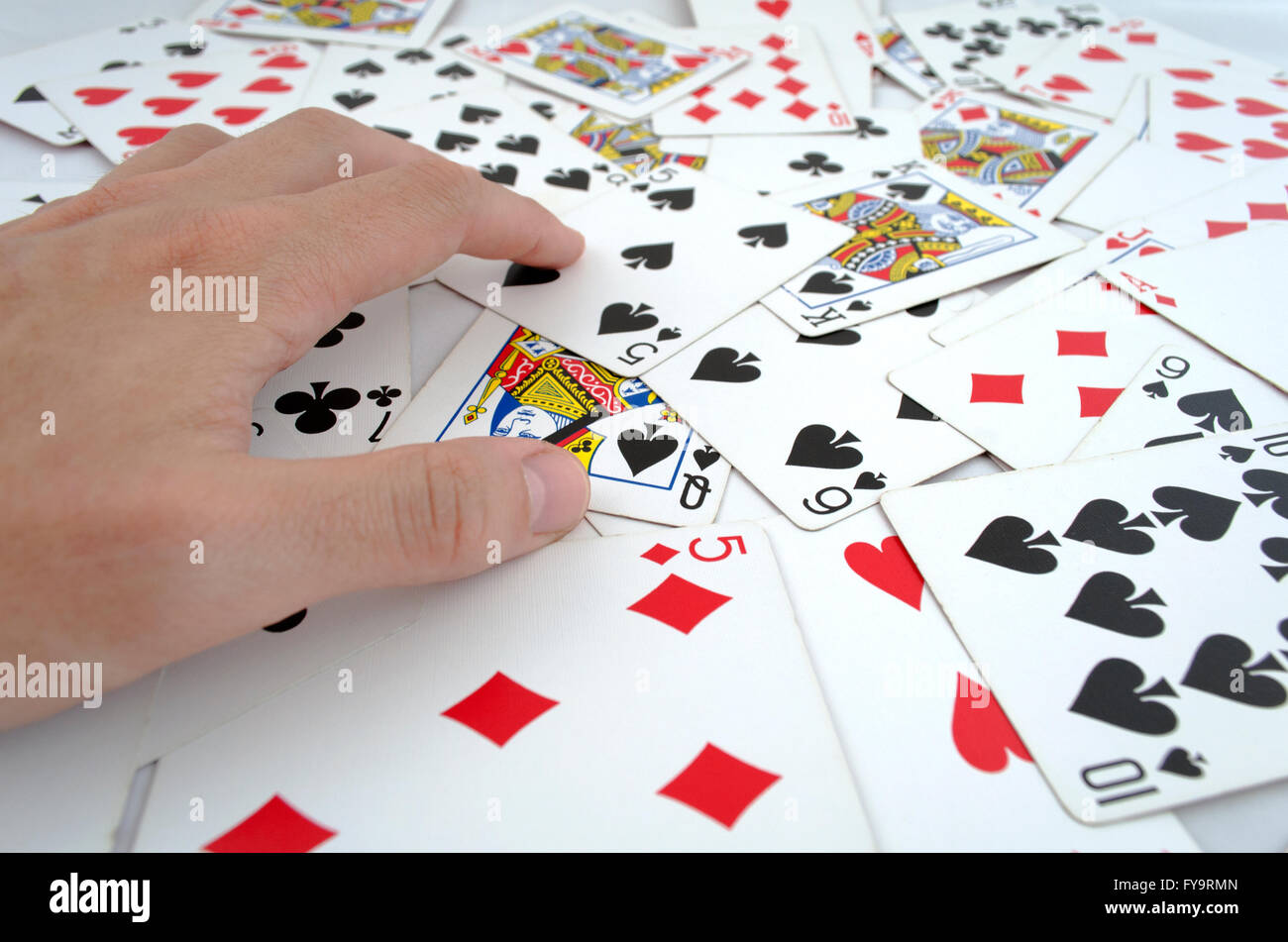 Playing cards in hand isolated on white background Stock Photo - Alamy