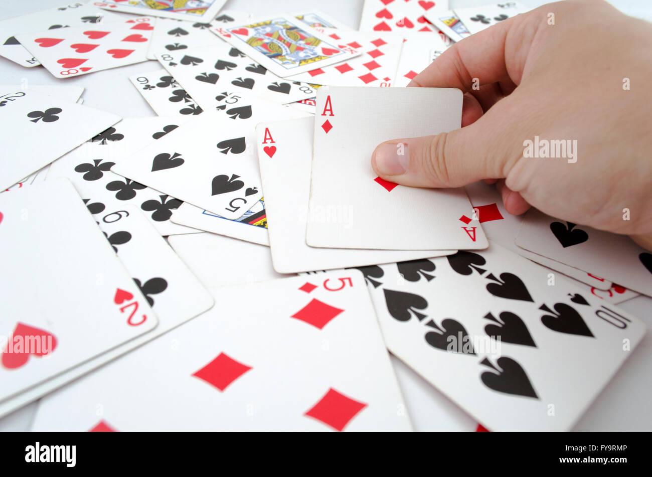 Playing cards in hand isolated on white background Stock Photo - Alamy