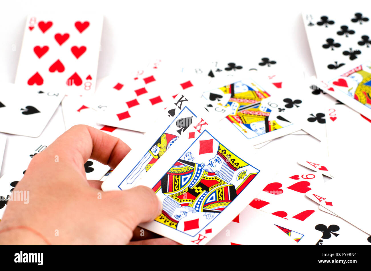 Playing cards in hand isolated on white background Stock Photo - Alamy
