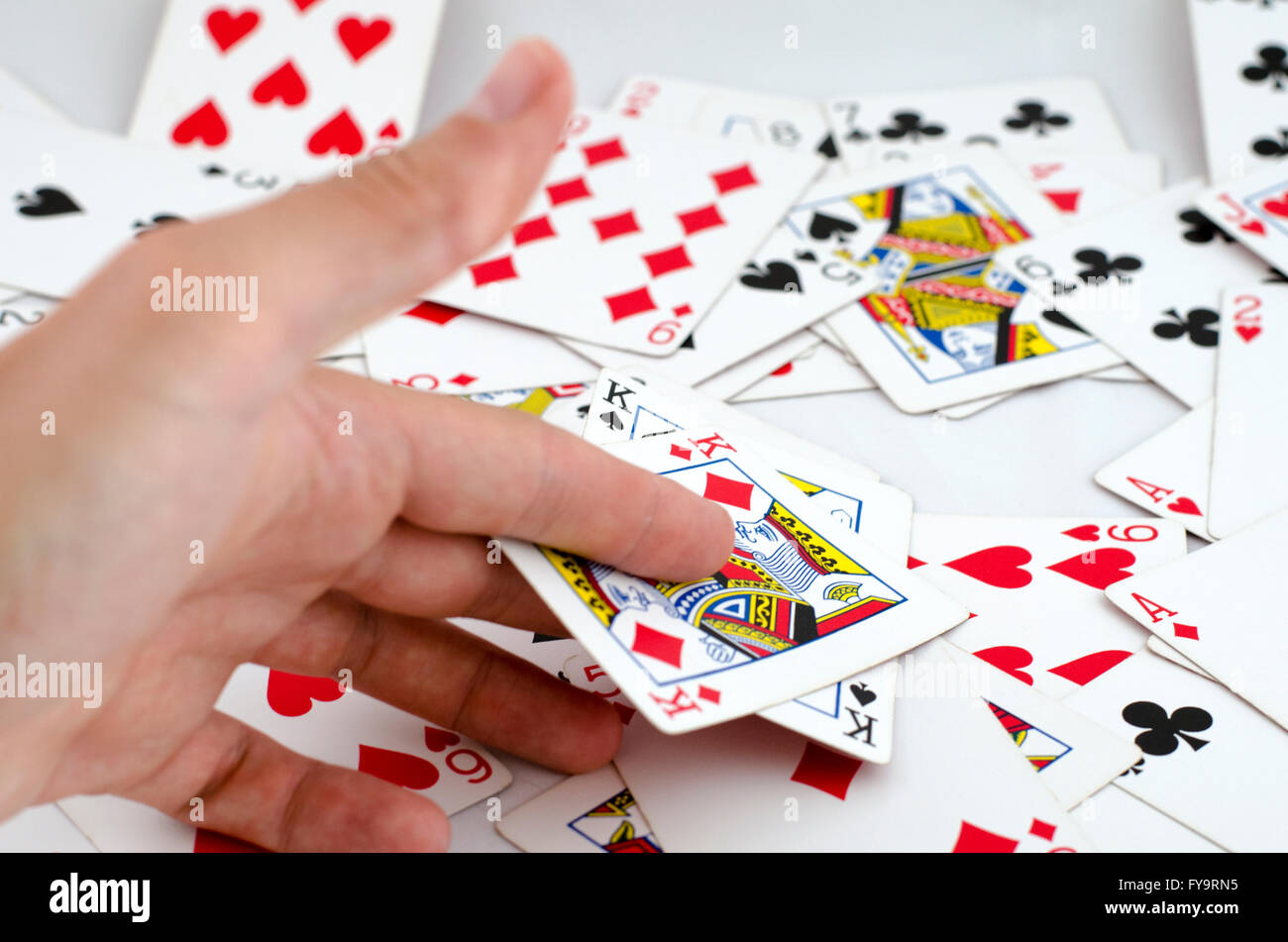 Playing cards in hand isolated on white background Stock Photo - Alamy