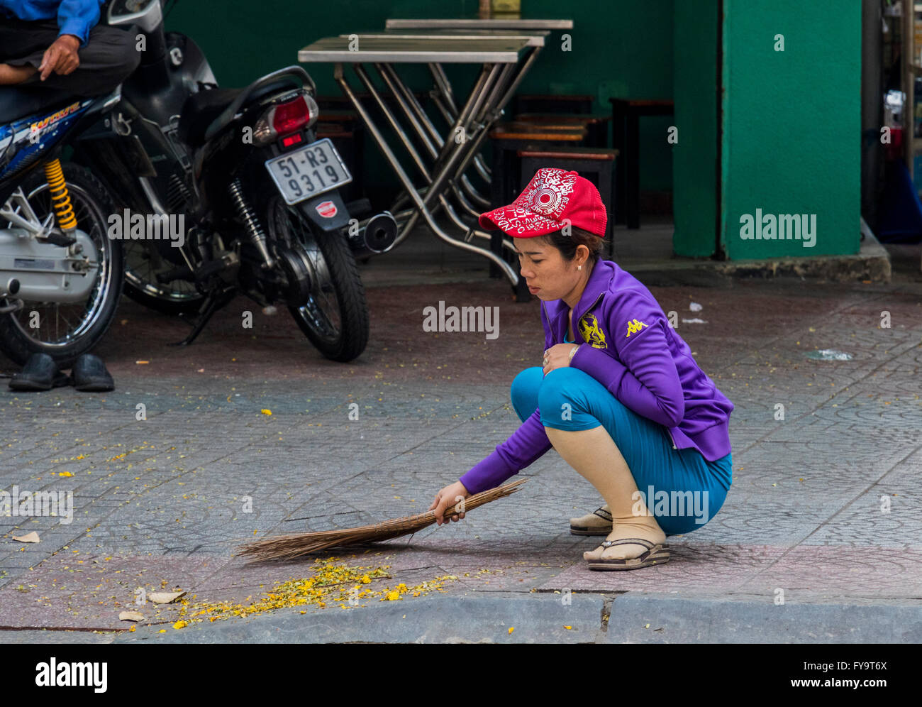Lady sweeping pavement Ho Chi Minh city Vietnam Stock Photo - Alamy