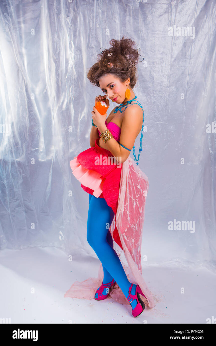 Beautiful girl in bright clothes and make up with colorful cherry ...