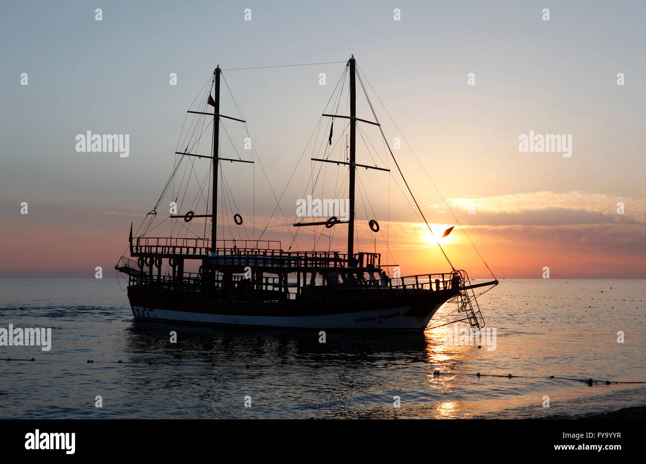 Excursion boat, sailing boat anchored on the beach at sunset, Manavgat ...