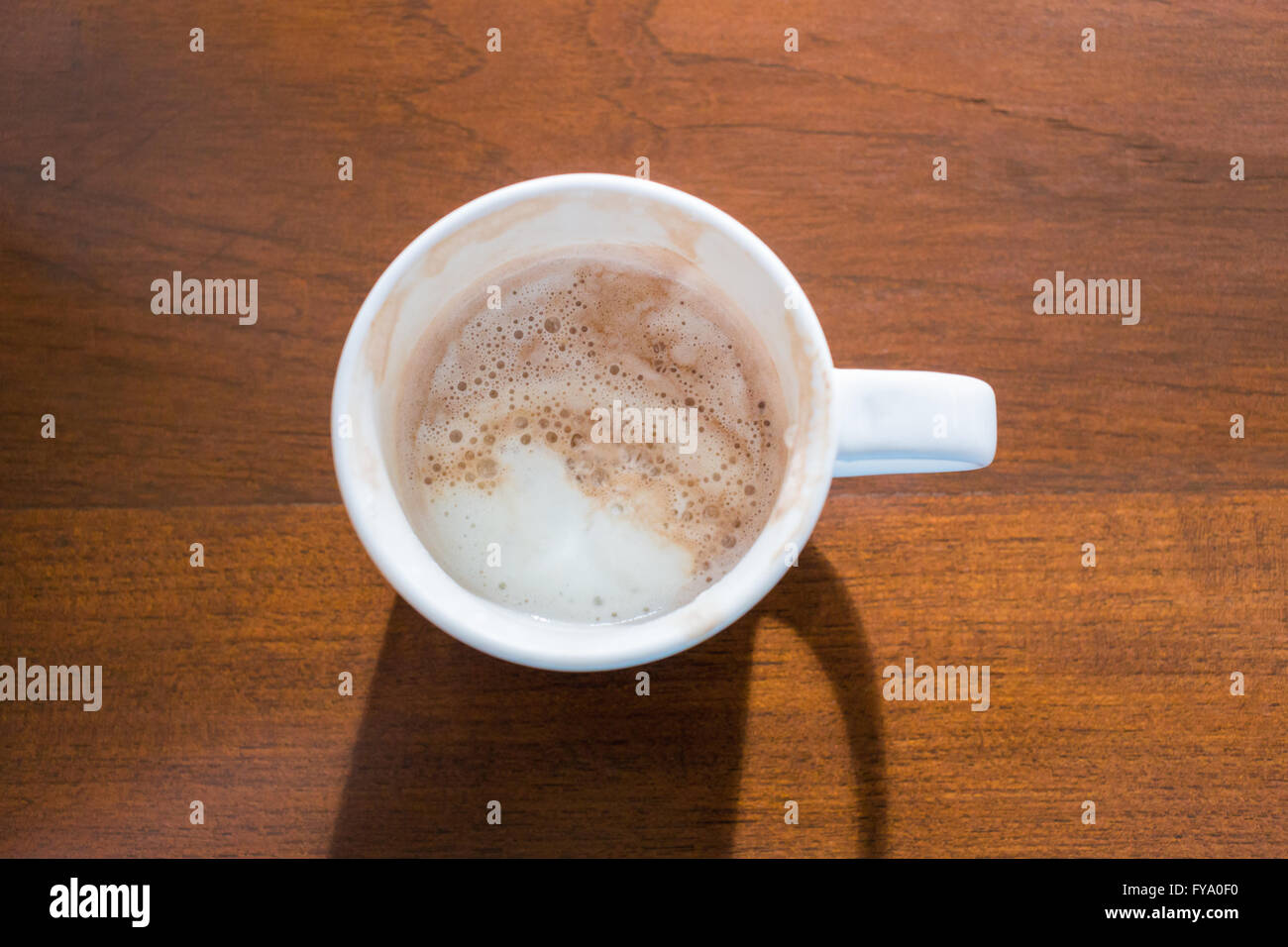 Close focus from top view on white cup of hot mocha coffee which ...