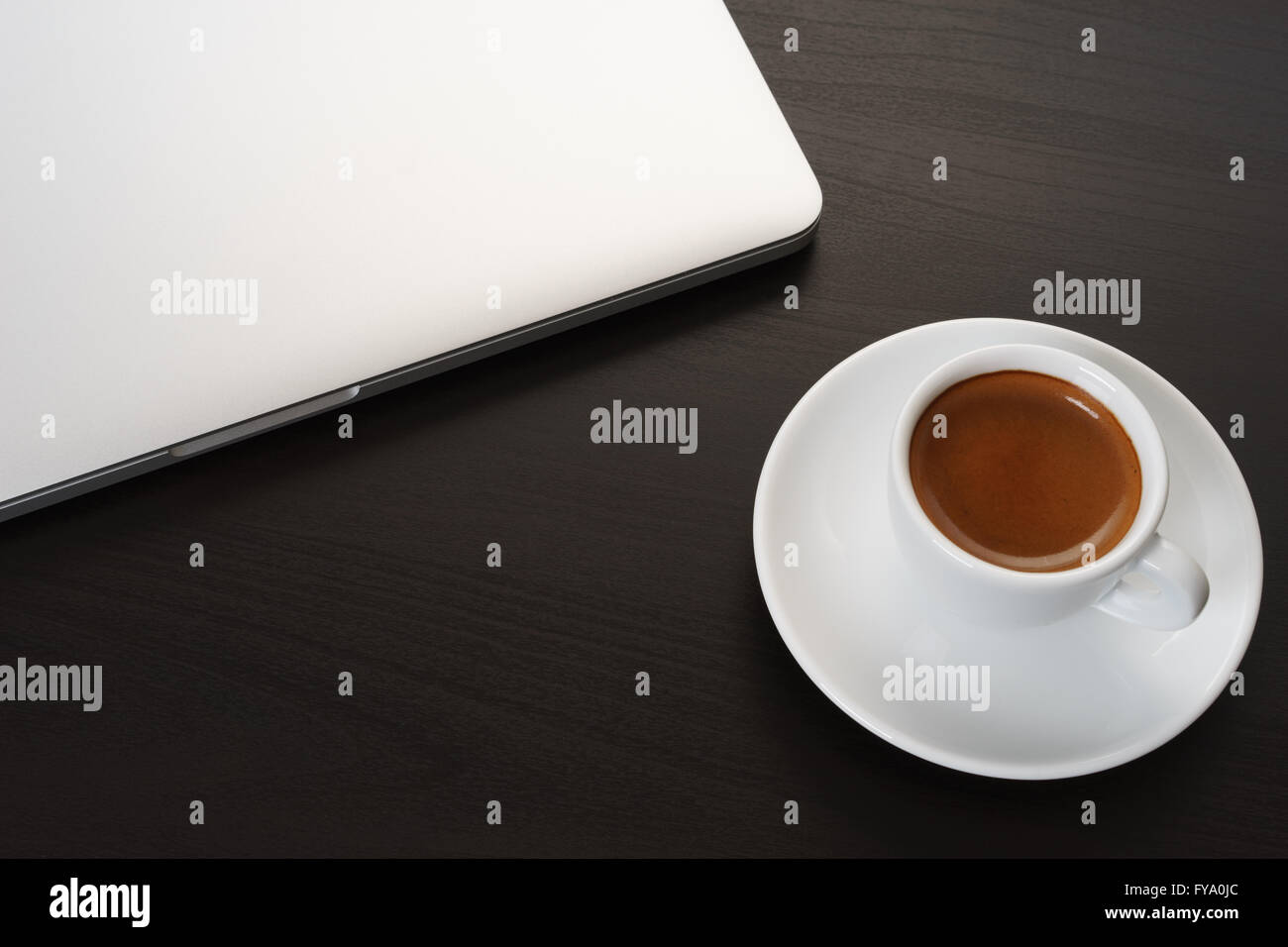 Laptop and coffee on office table Stock Photo - Alamy