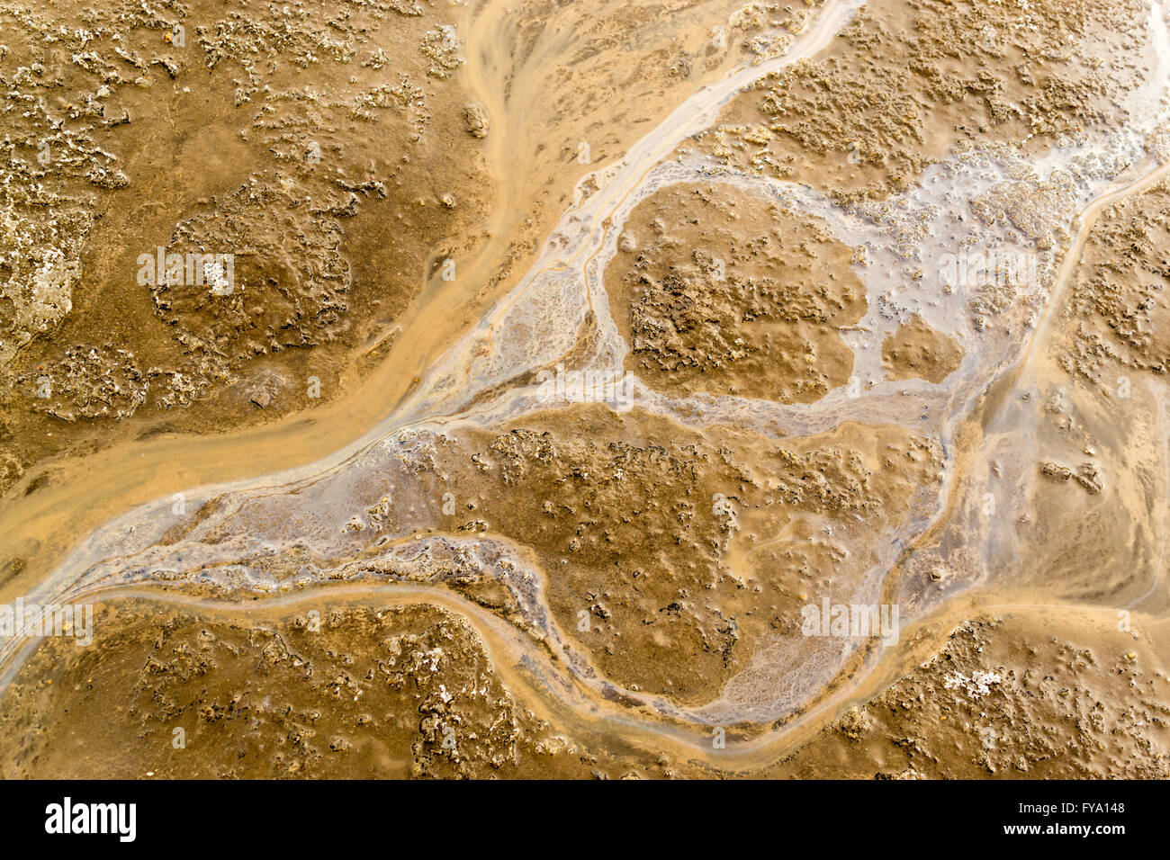 Vibrant colours of a mechanical oil spill on water creating a polluted ...