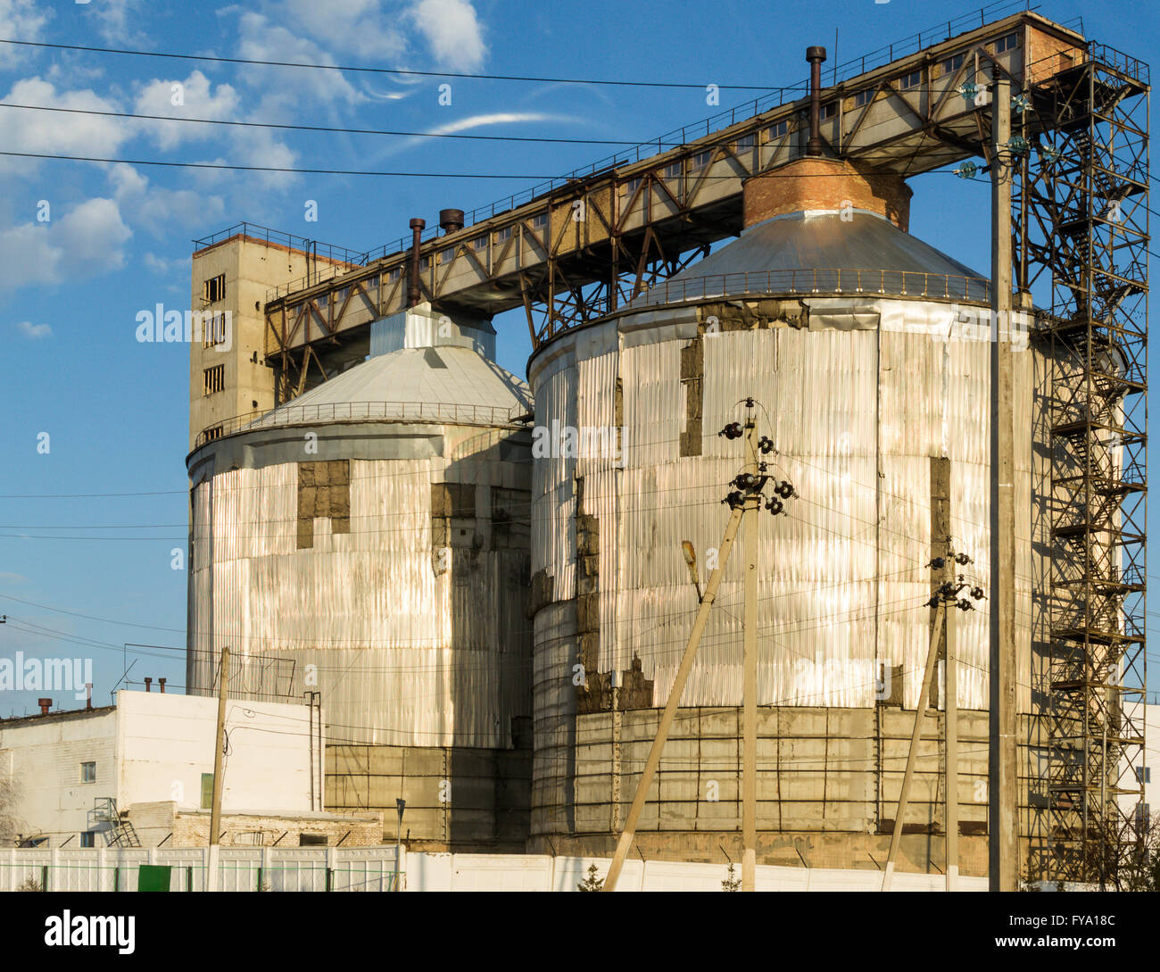 Large old soviet style aged factory with large silver coloured metallic ...