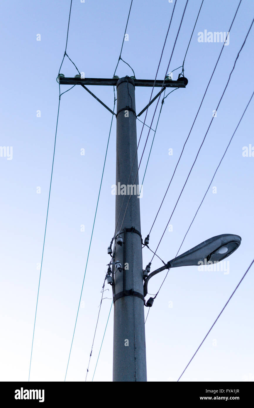 Old electricity post with cables, porcelain insulators and a street ...