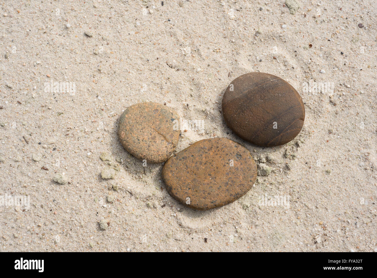 three zen stones with copy space lying on the beach Stock Photo - Alamy