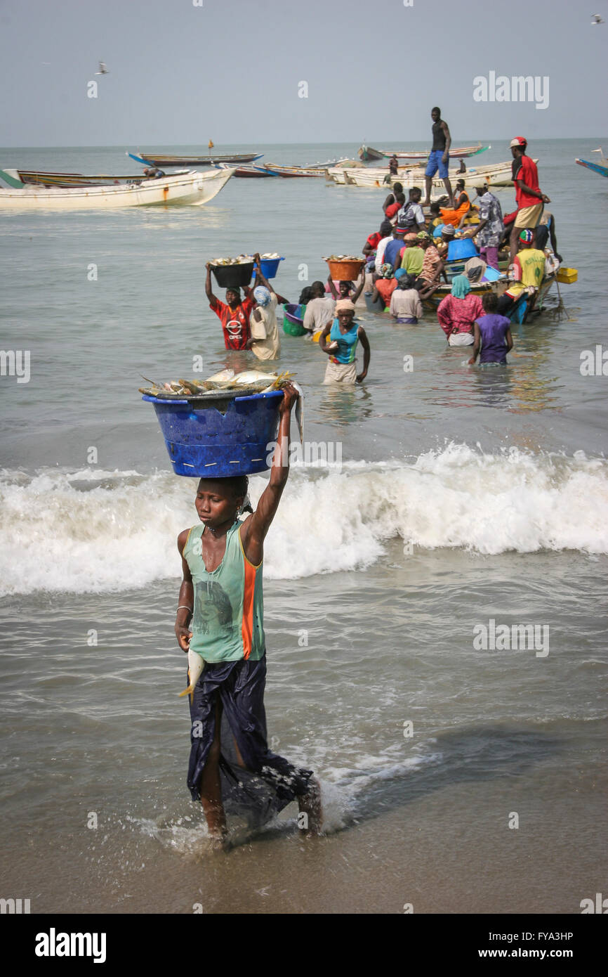 African women carrying buckets on their heads full of fishes from ...