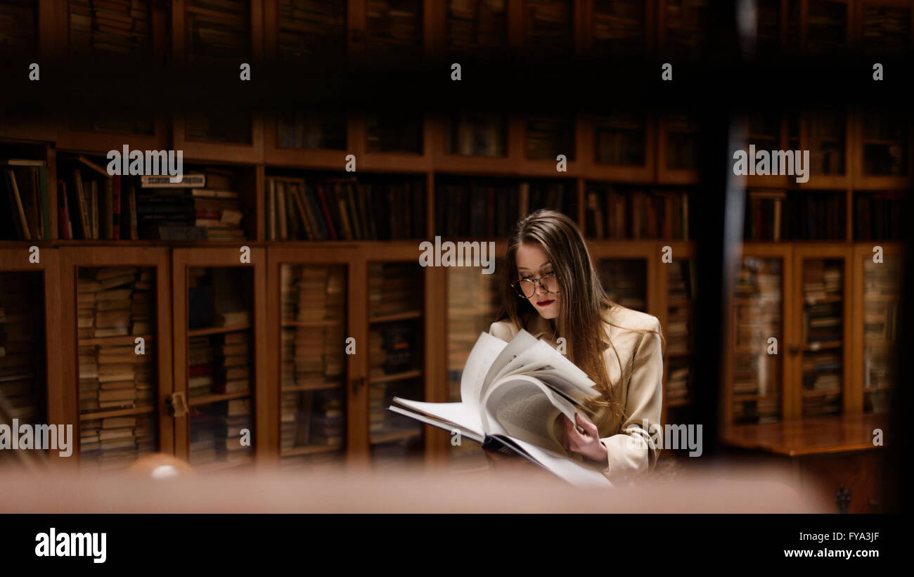 Lovely stylish student girl studying in the library Stock Photo - Alamy
