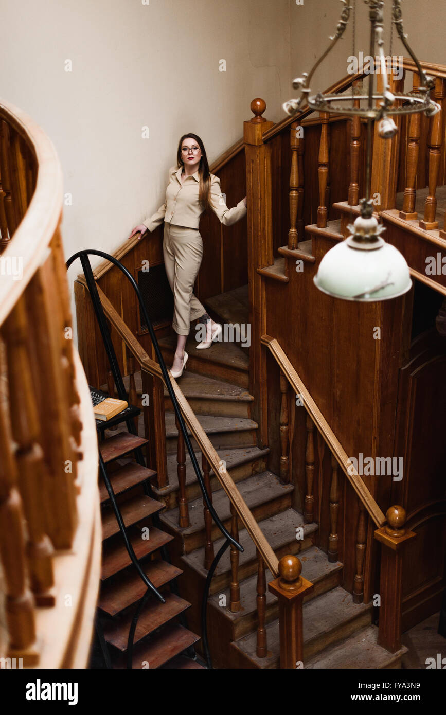 Beautiful stylish lady in suit wallks downstairs Stock Photo - Alamy