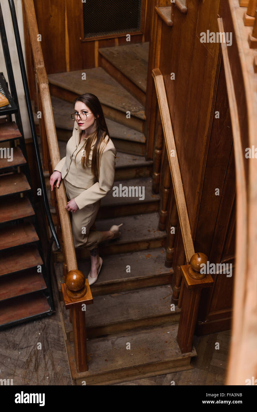 Beautiful stylish lady in suit wallks downstairs Stock Photo - Alamy