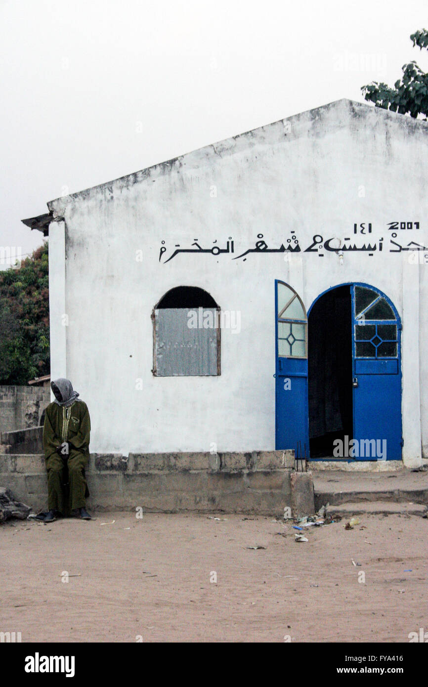 Everyday life at Tanji village, man outside an islamic temple with ...