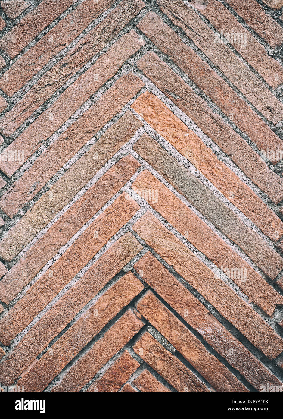 Fish bone texture of aged red bricks, pointing up detail vertical close ...