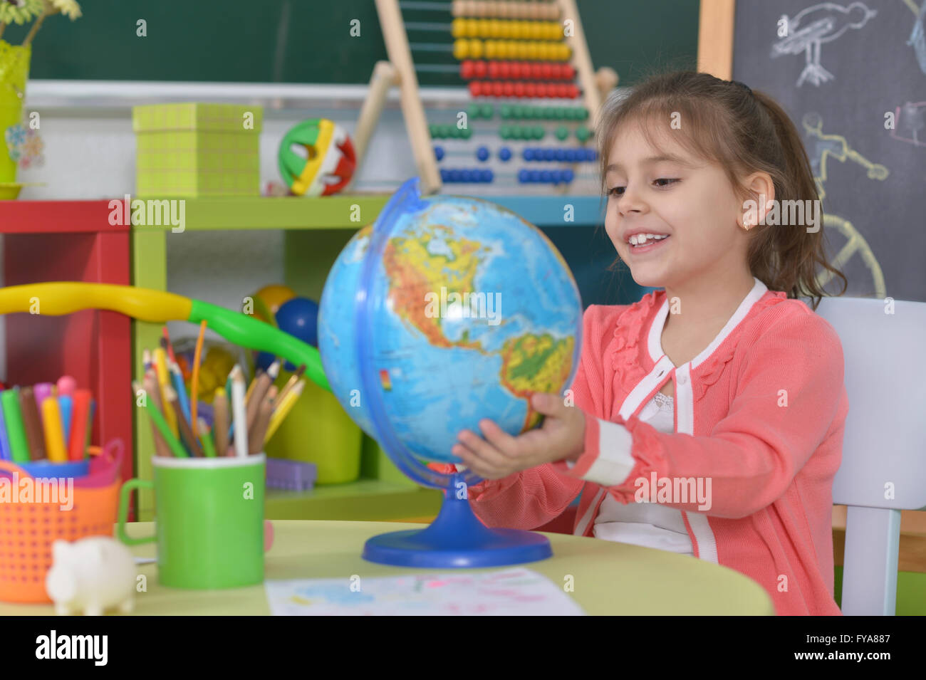 Beautiful little girl at classroom Stock Photo - Alamy