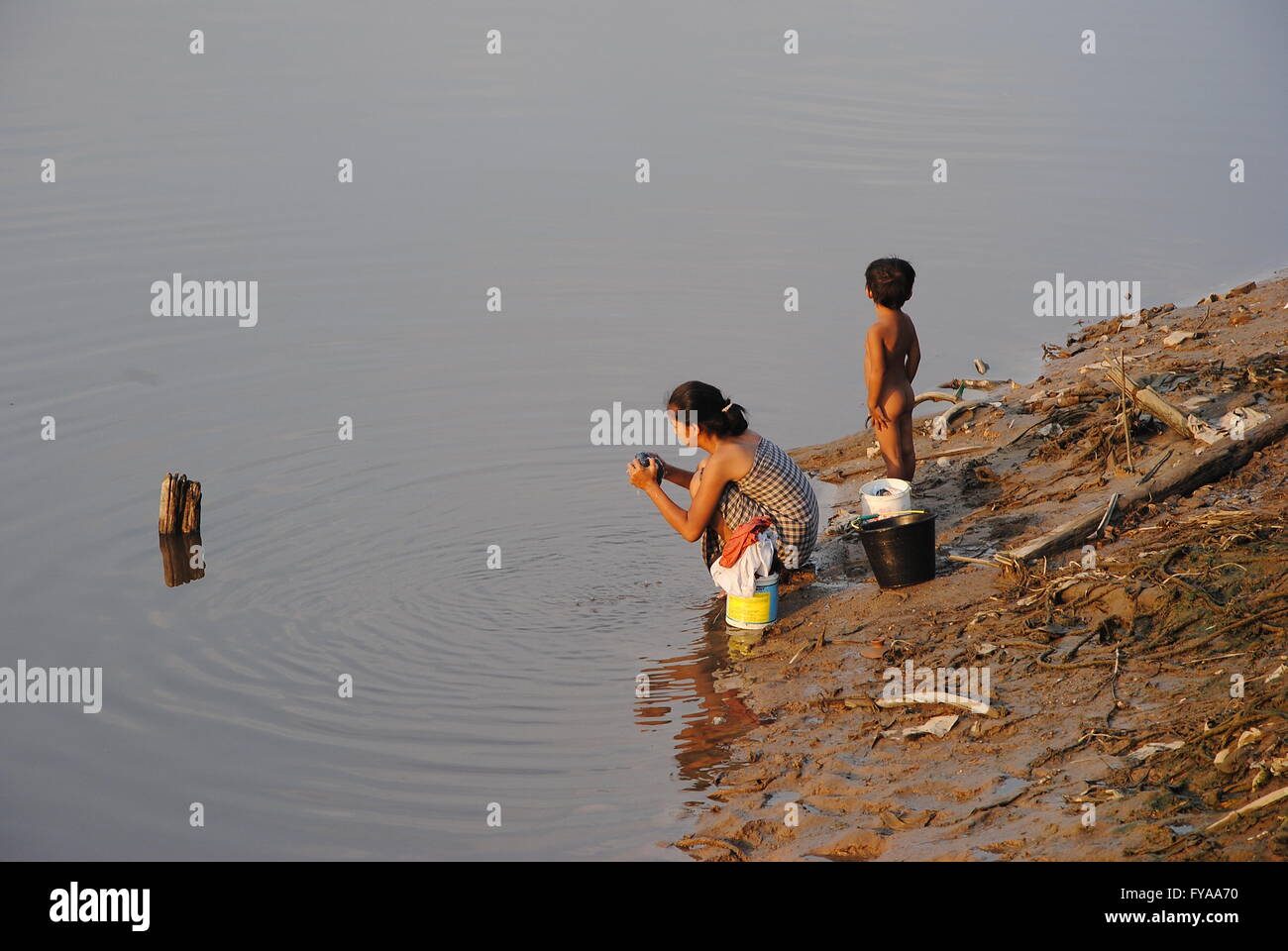 Child washing in river hi-res stock photography and images - Alamy