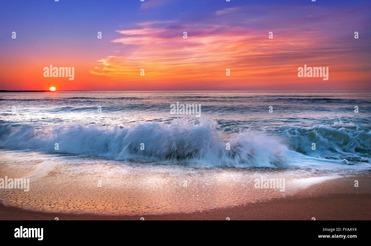 Colorful ocean beach sunrise Stock Photo - Alamy