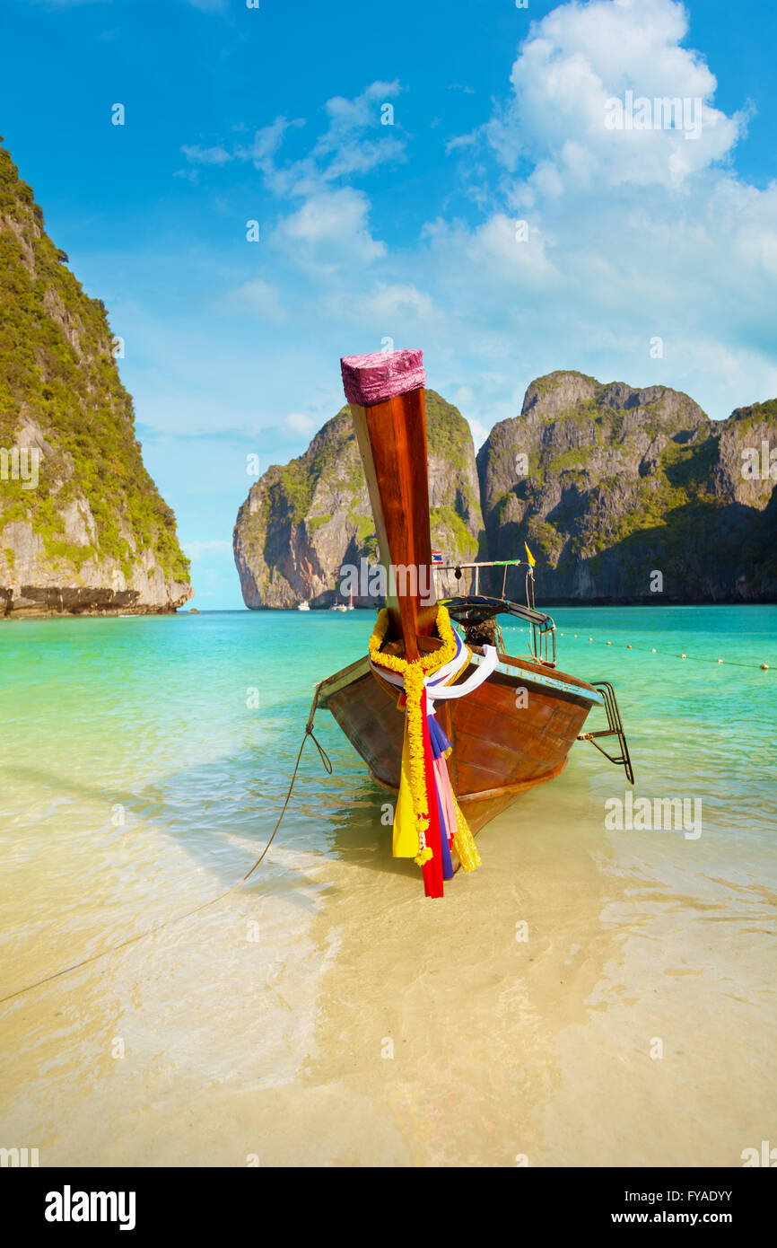Traditional longtail boat, decorated with colorful garlands and ...