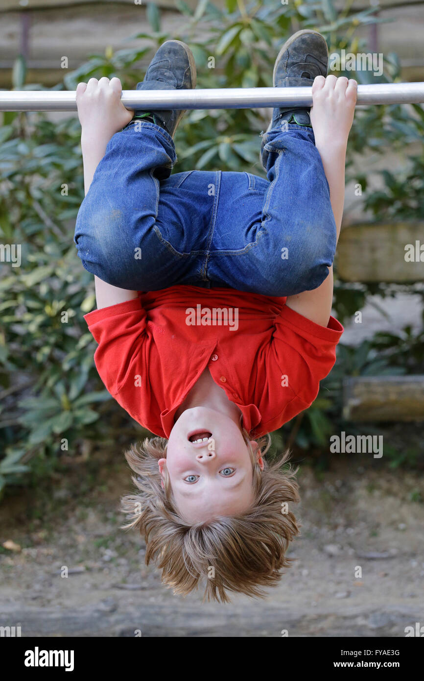 boy hanging headlong Stock Photo - Alamy