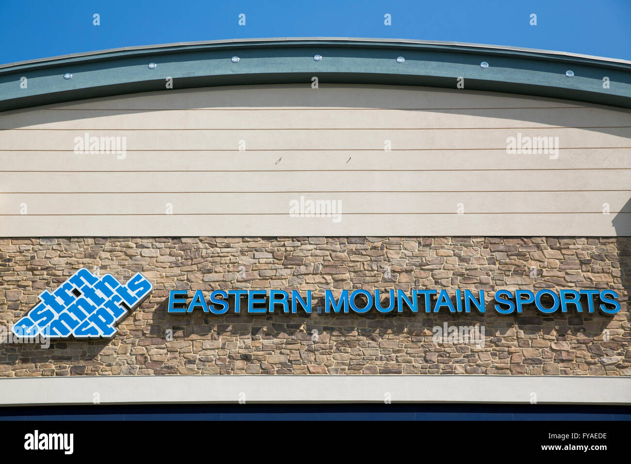 A logo sign outside of an Eastern Mountain Sports retail store in ...