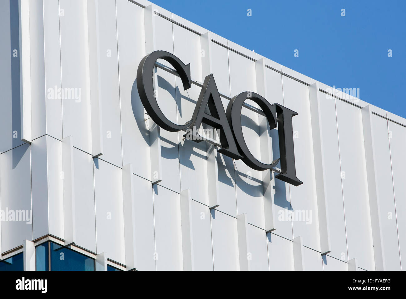 A logo sign outside of a facility occupied by CACI International, Inc ...