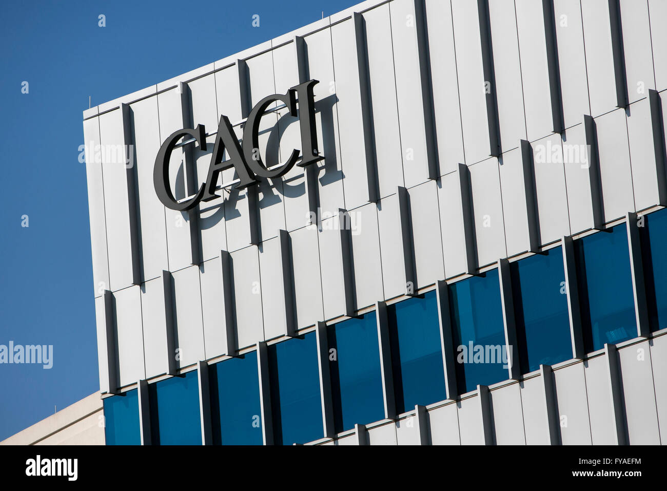 A logo sign outside of a facility occupied by CACI International, Inc ...