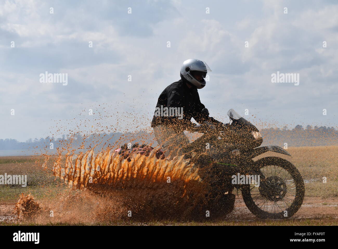 Riding motorcycle through the mud Stock Photo - Alamy