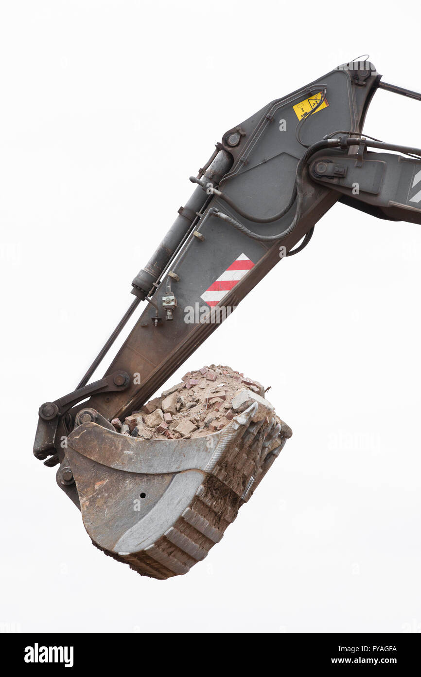 A demolition site in UK. Heavy plant machines demolishing an old school ...