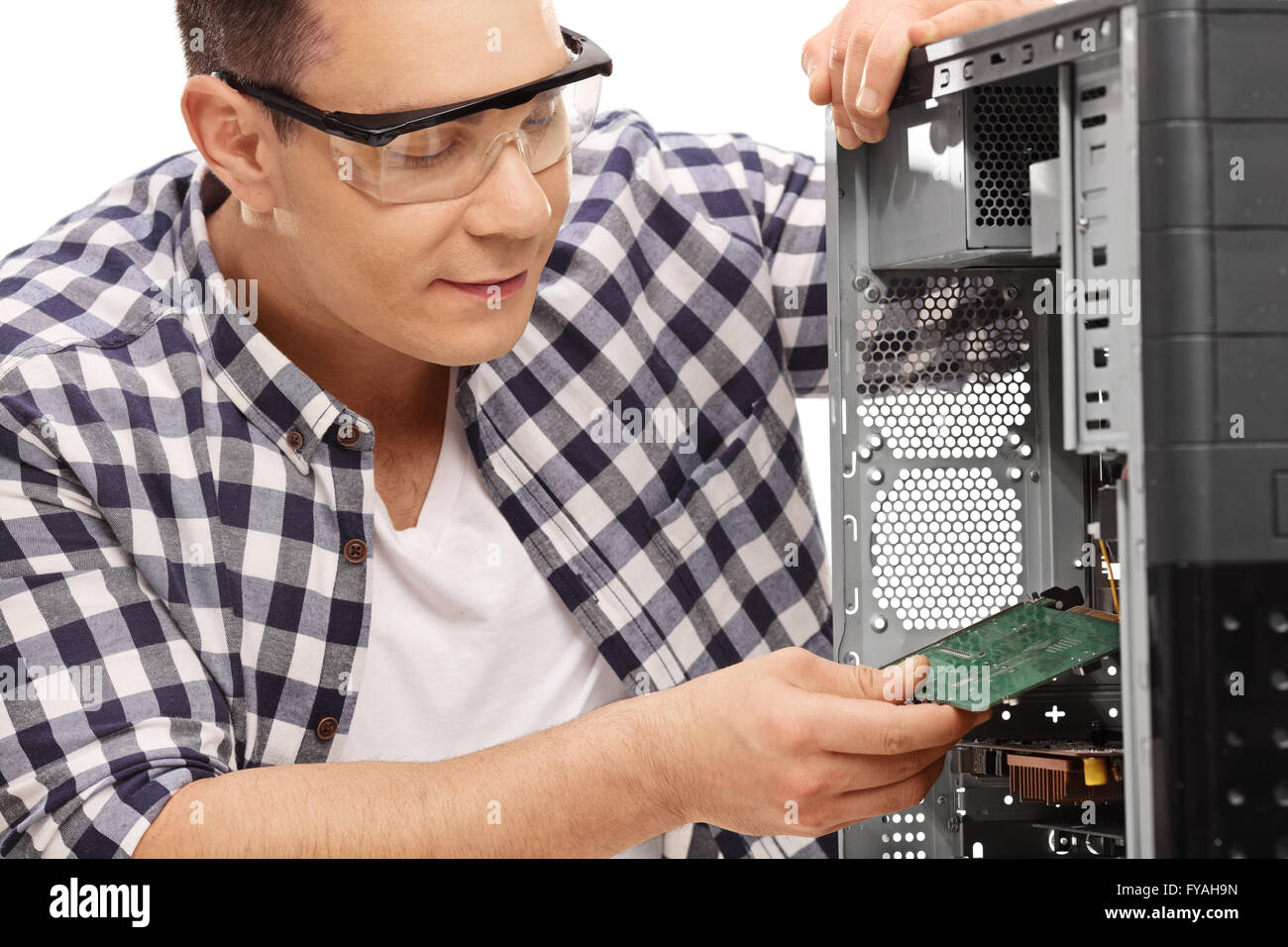 Young PC technician assembling a desktop computer isolated on white ...