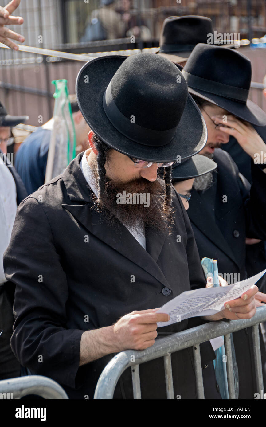 A religious Jewish man reading a prayer at the annual burning of bread ...